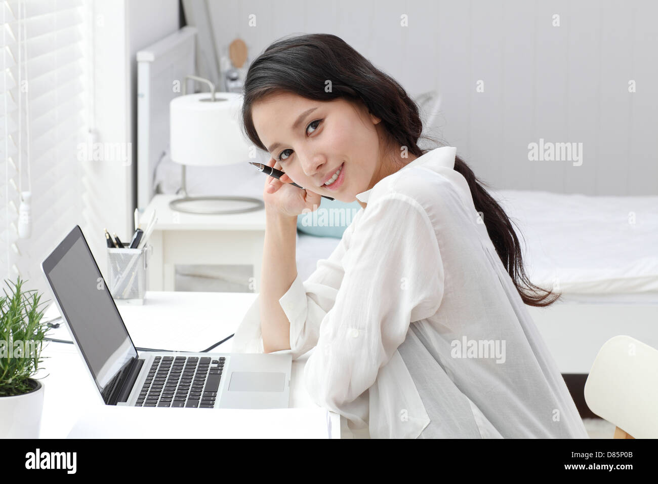 young woman sitting desk computer Stock Photo - Alamy