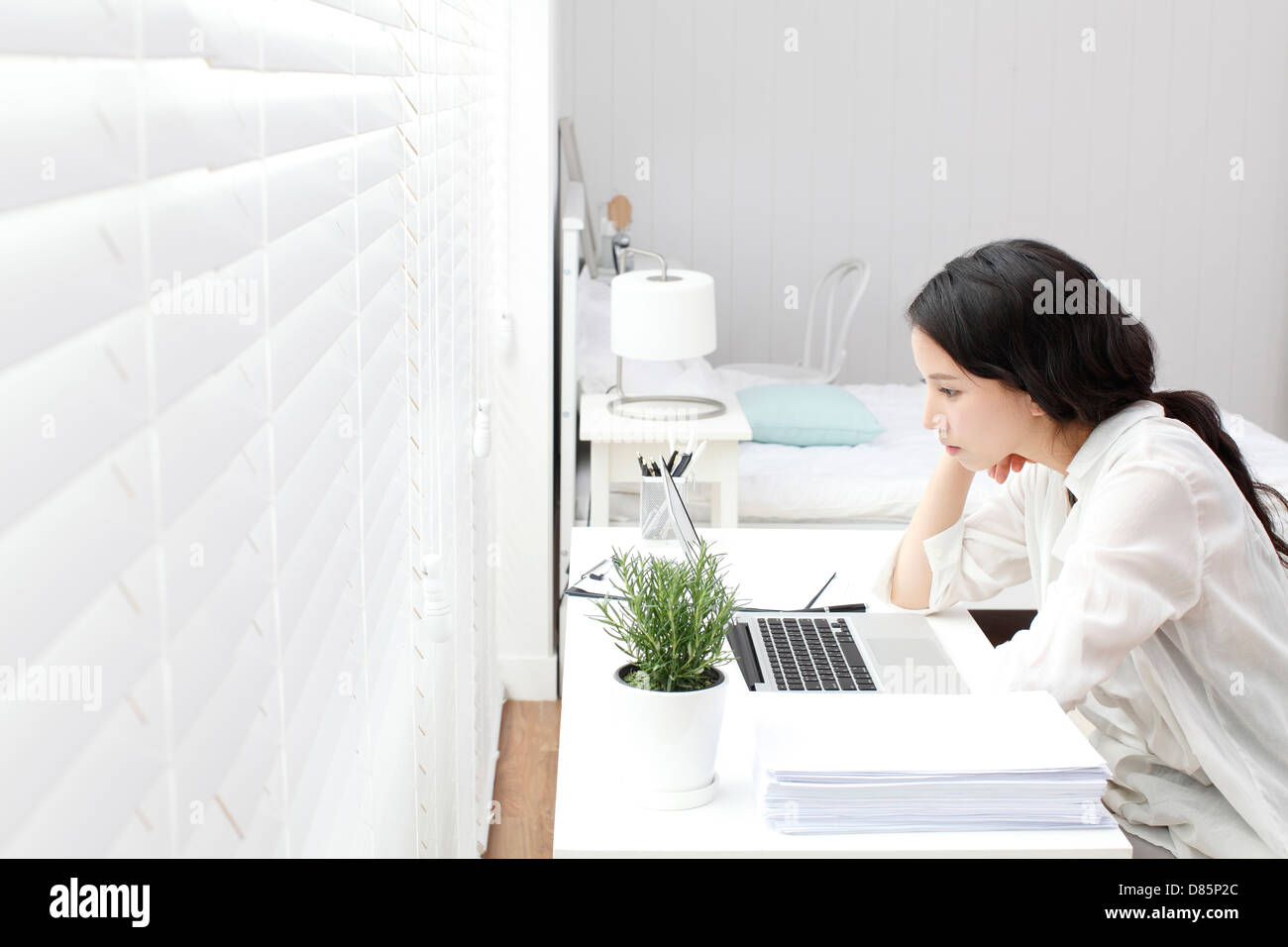 young woman sitting desk computer Stock Photo - Alamy