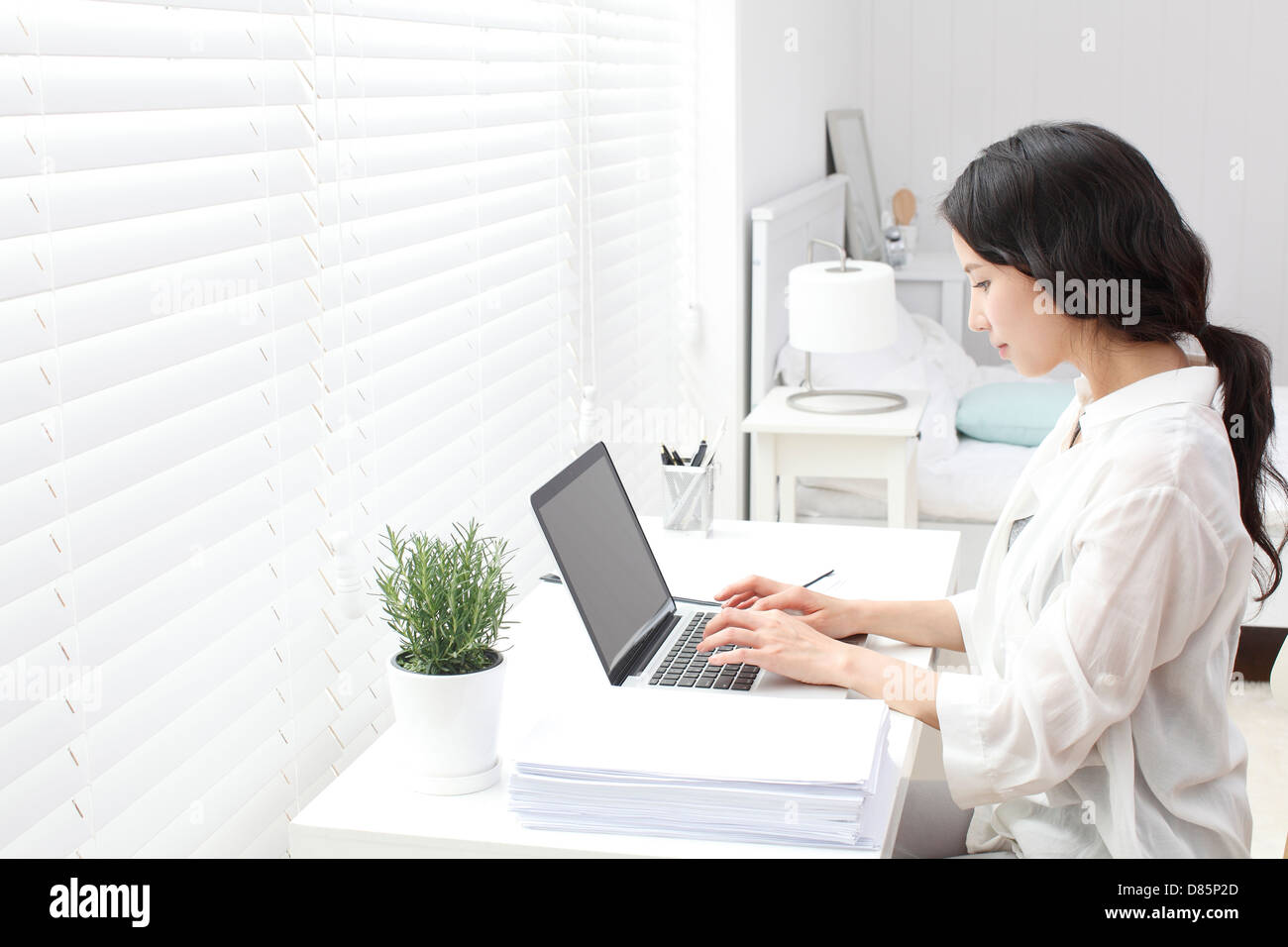 young woman sitting desk computer Stock Photo - Alamy