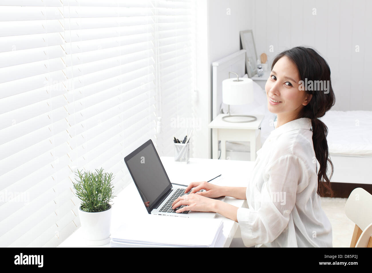 young woman sitting desk computer Stock Photo - Alamy