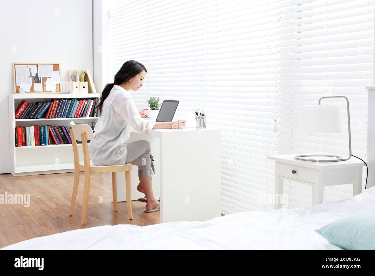 young woman sitting desk computer Stock Photo - Alamy