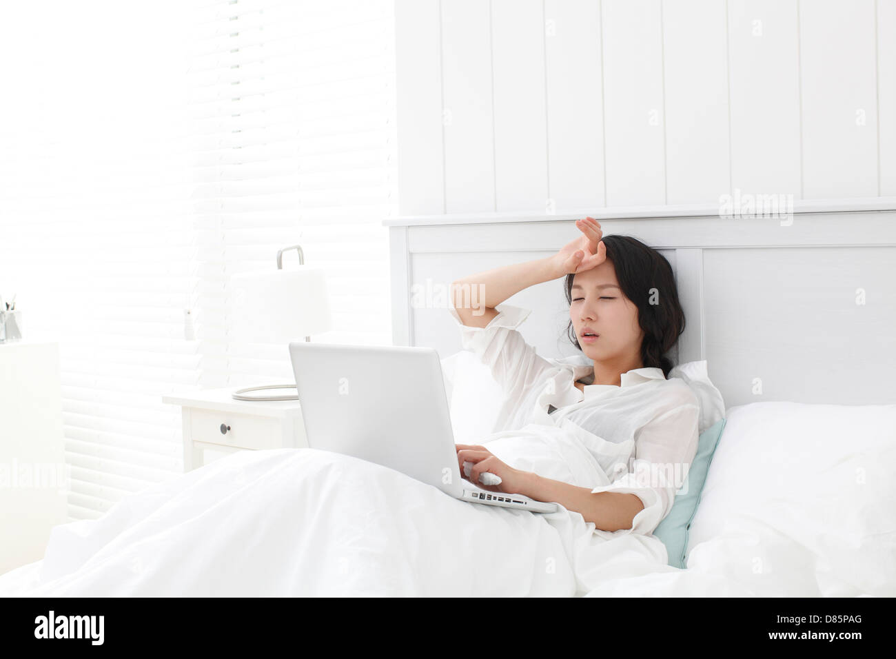 sick young woman studying in bed Stock Photo - Alamy