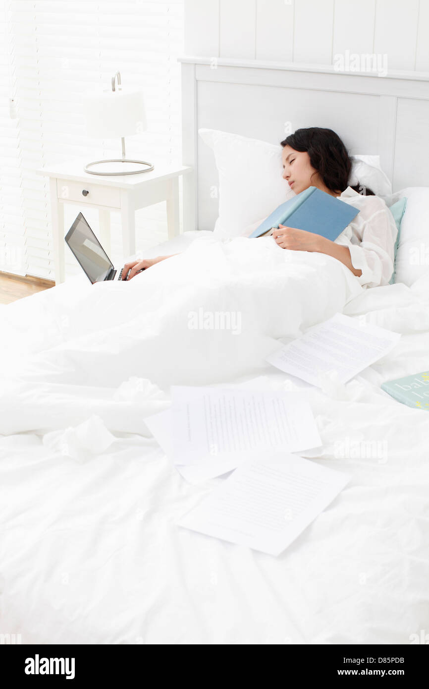 sick young woman studying in bed Stock Photo - Alamy