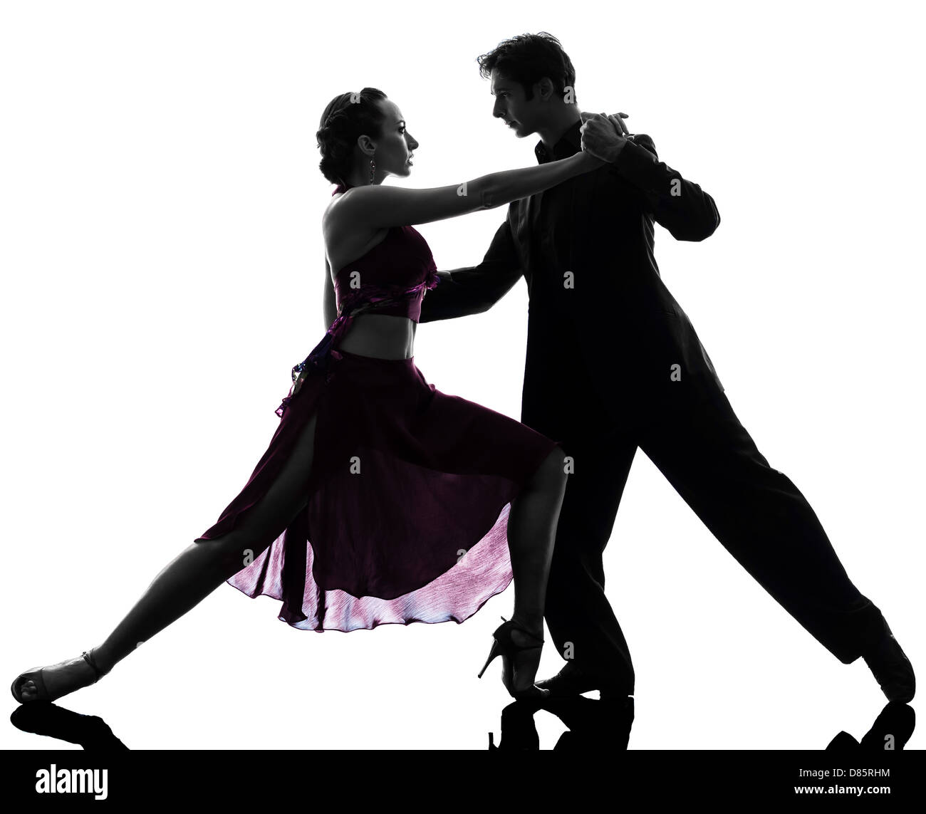 one couple man woman ballroom dancers tangoing in silhouette studio ...