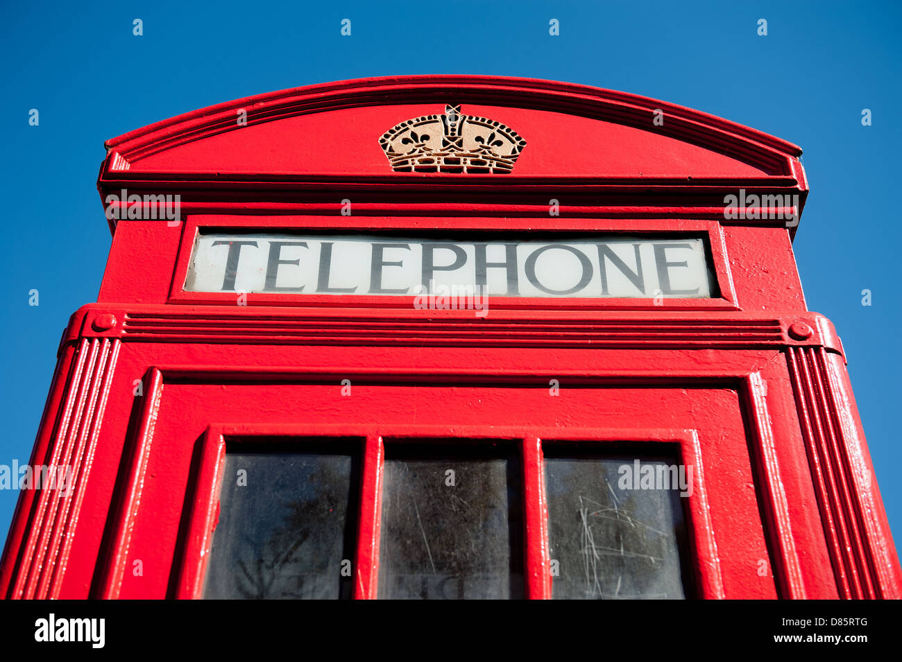 Old style red British telephone box against a clear blue sky Stock ...