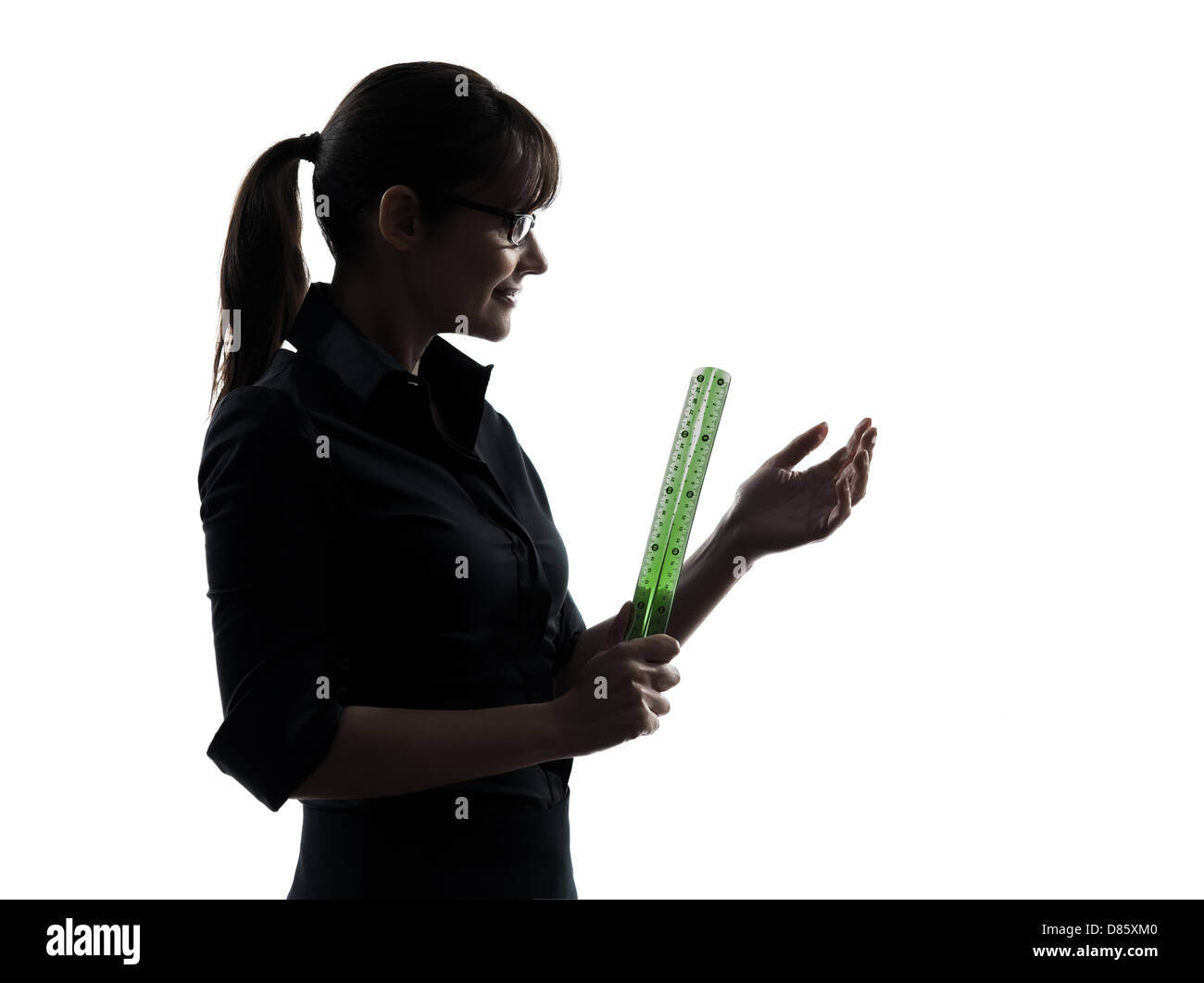 one business woman teacher holding ruler silhouette studio isolated on ...