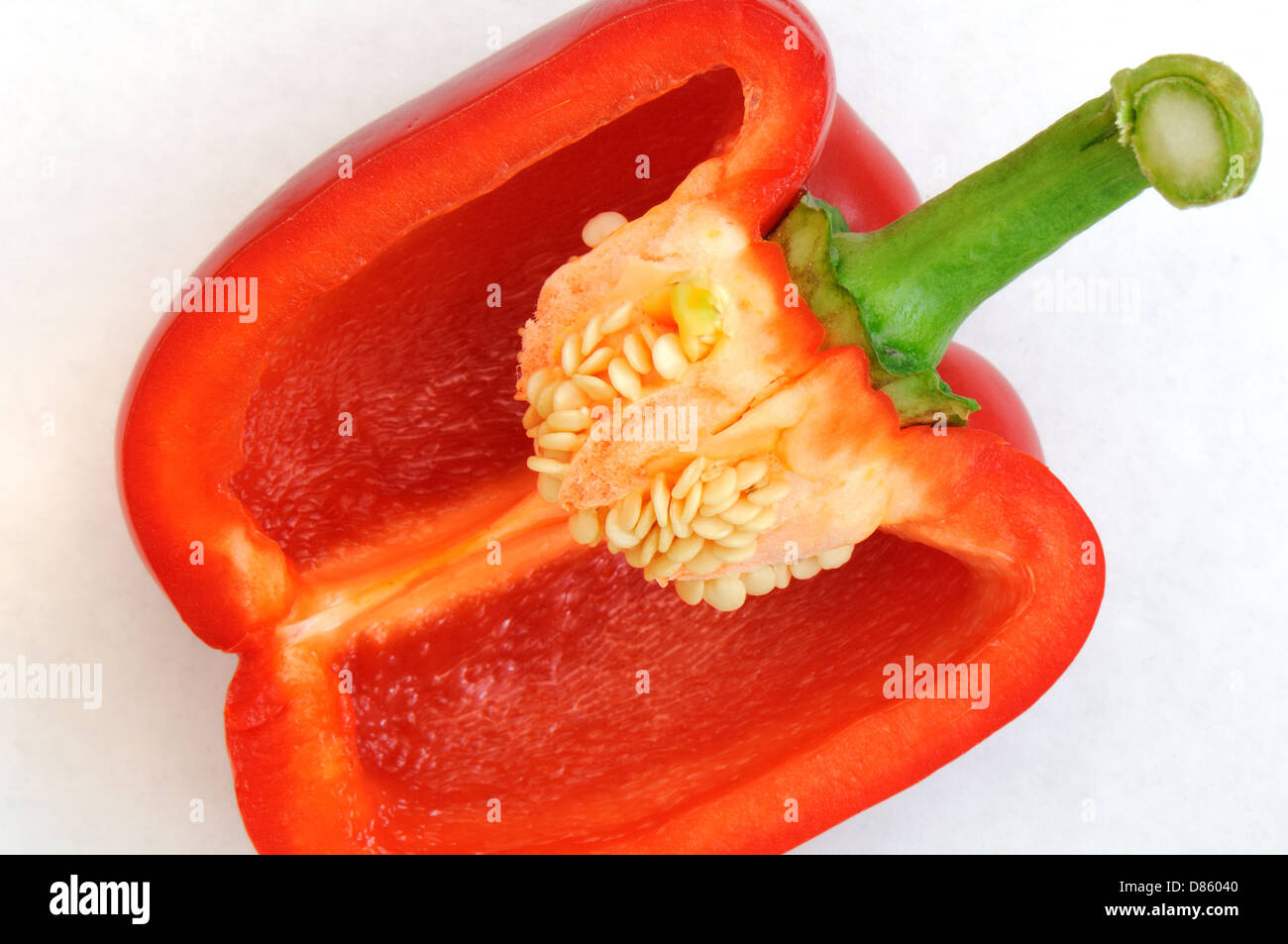 Halved red pepper with seeds and stalk Stock Photo - Alamy