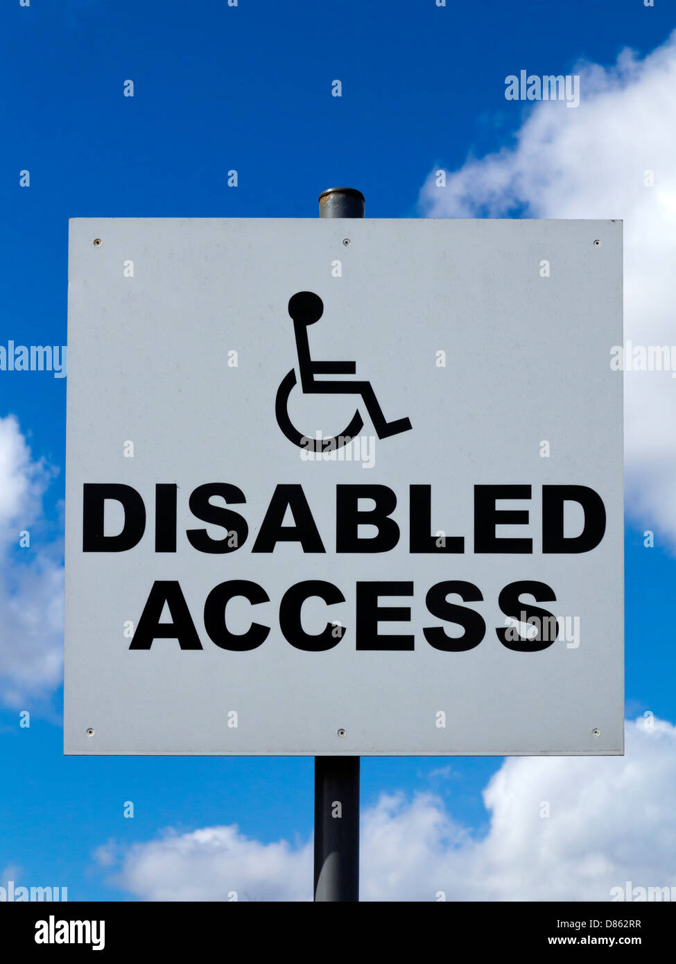Disabled Access sign with wheelchair logo and blue sky behind Stock ...