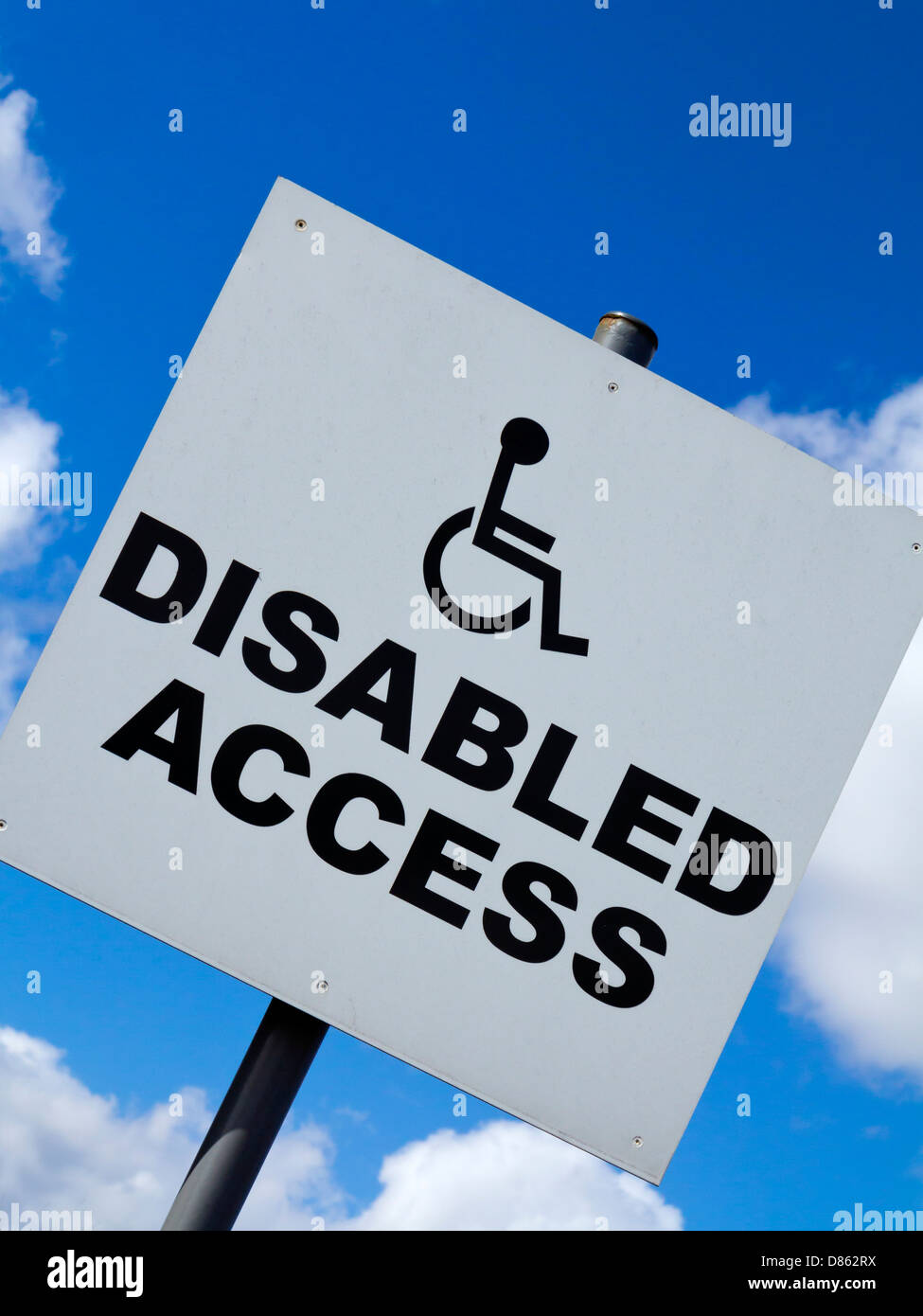 Disabled Access sign with wheelchair logo and blue sky behind Stock ...