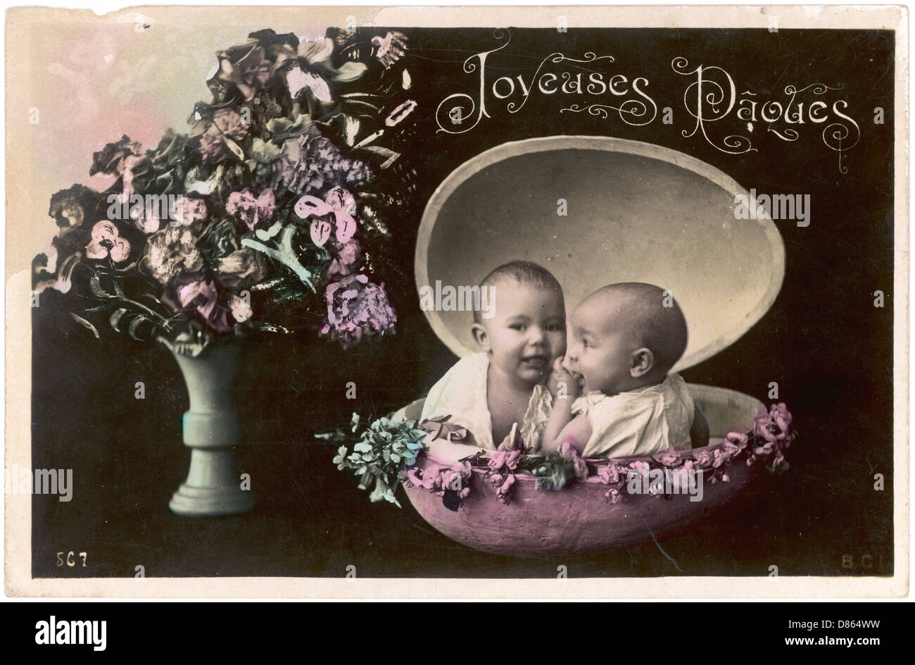 Two babies inside a large Easter egg Stock Photo - Alamy