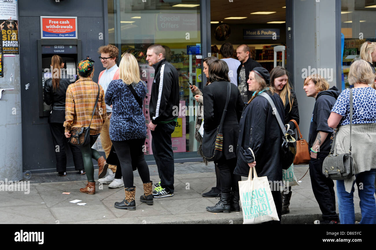 People queue for a cash machine in Brighton UK Stock Photo - Alamy