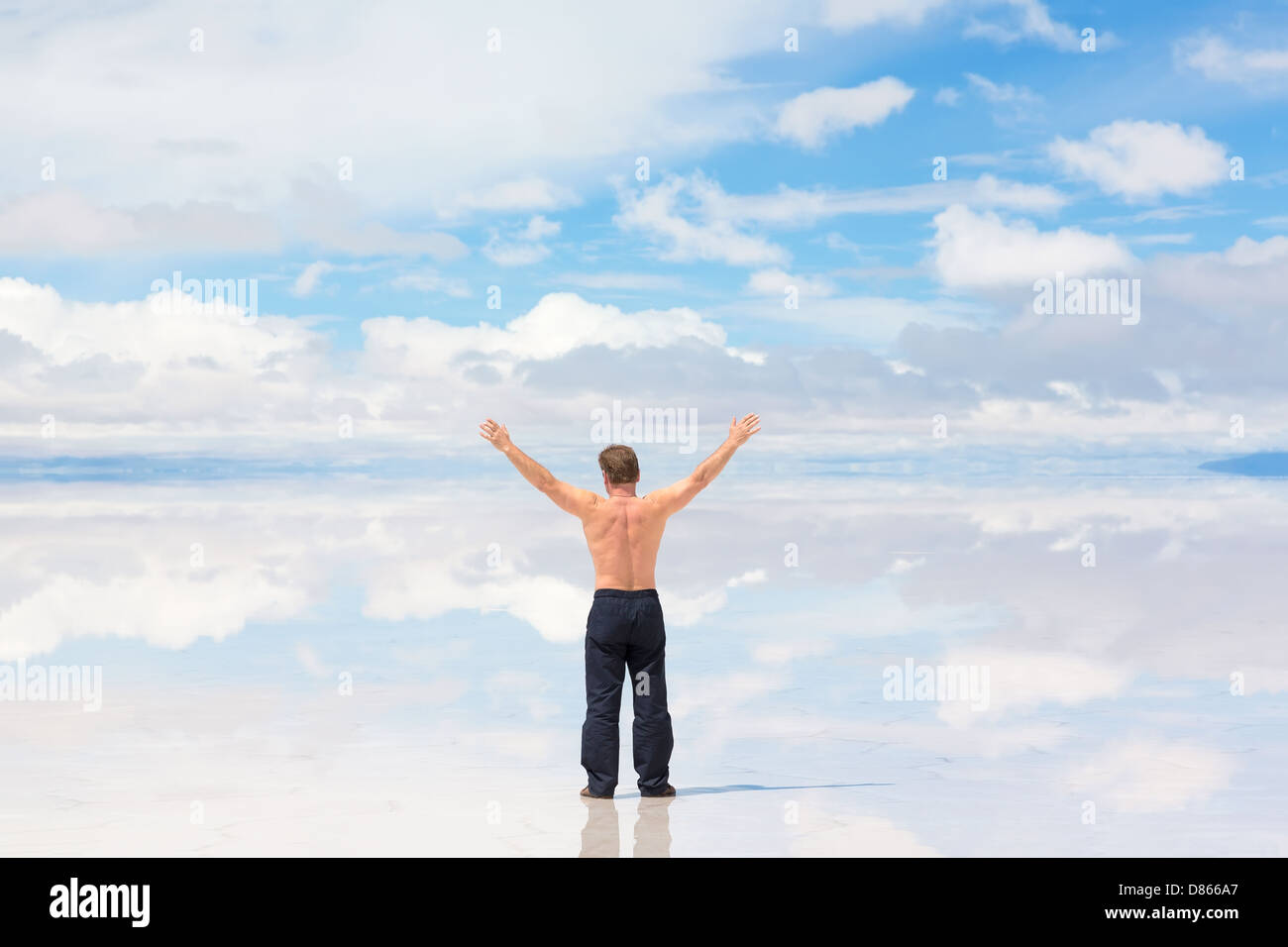 Man with hands raised Stock Photo - Alamy