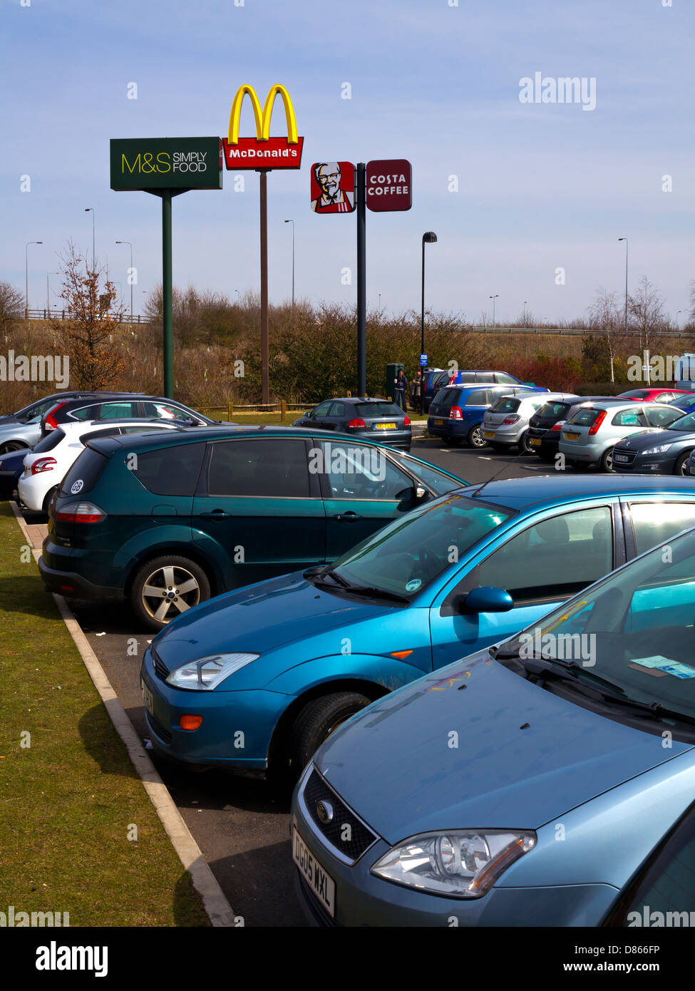 KFC M&S McDonalds and Costa Coffee signs on poles at Peterborough ...