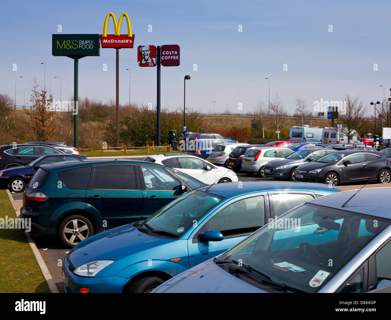 KFC M&S McDonalds and Costa Coffee signs on poles at Peterborough ...