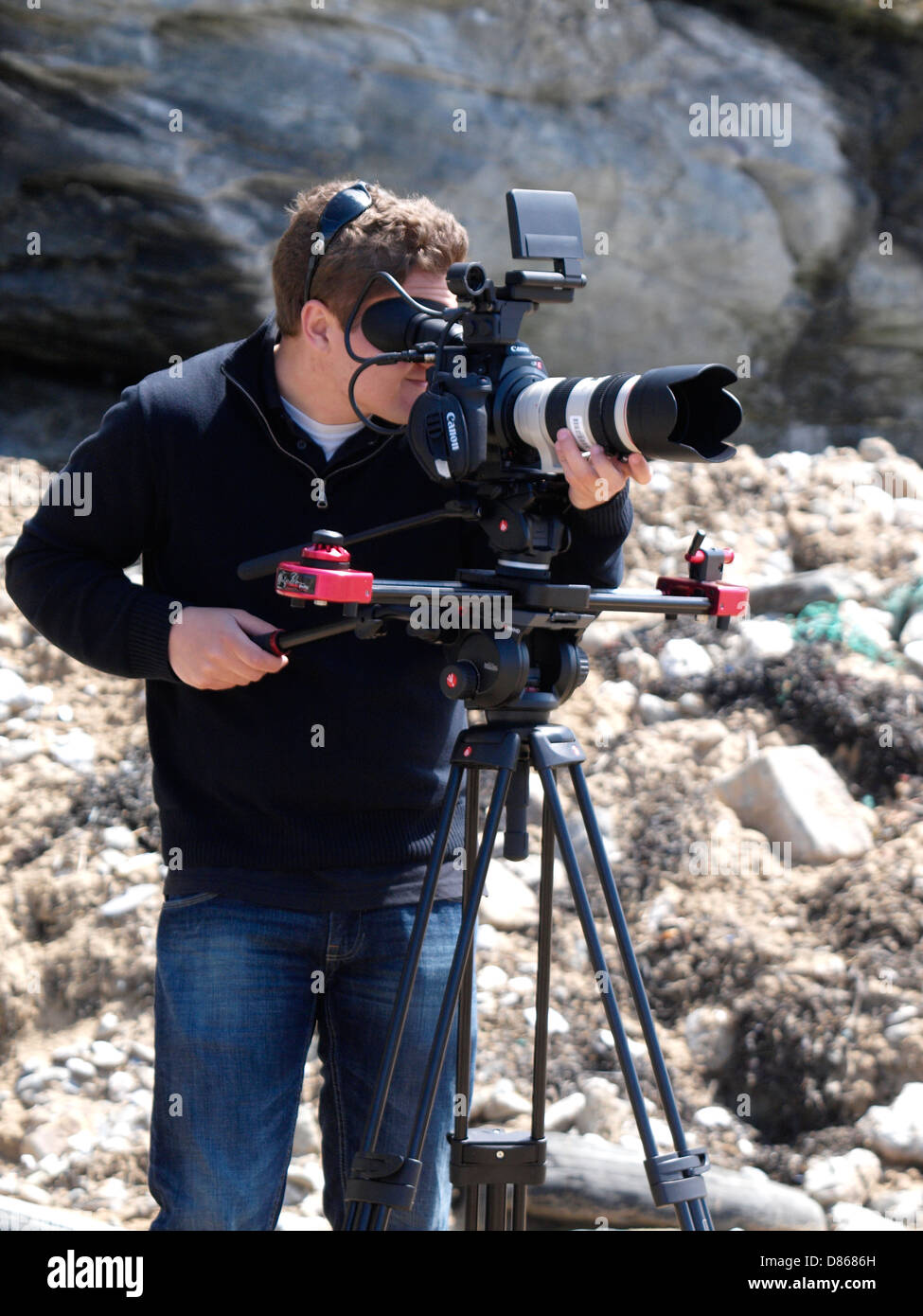Cameraman filming with a Canon DSLR, UK 2013 Stock Photo - Alamy