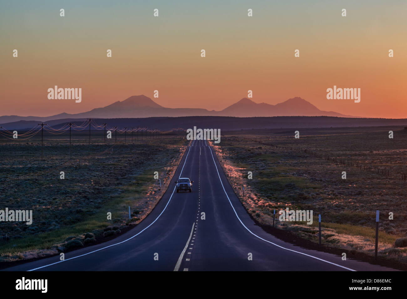 Route 20 westbound into sunset, Cascade Mountains, Oregon Stock Photo ...