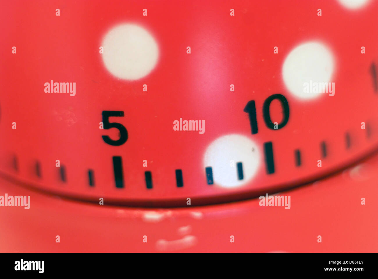 Close up of red and white spotty egg timer with numbers and gradations ...