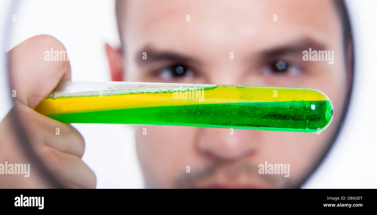 Closeup of man with magnifying glass and test tube Stock Photo - Alamy