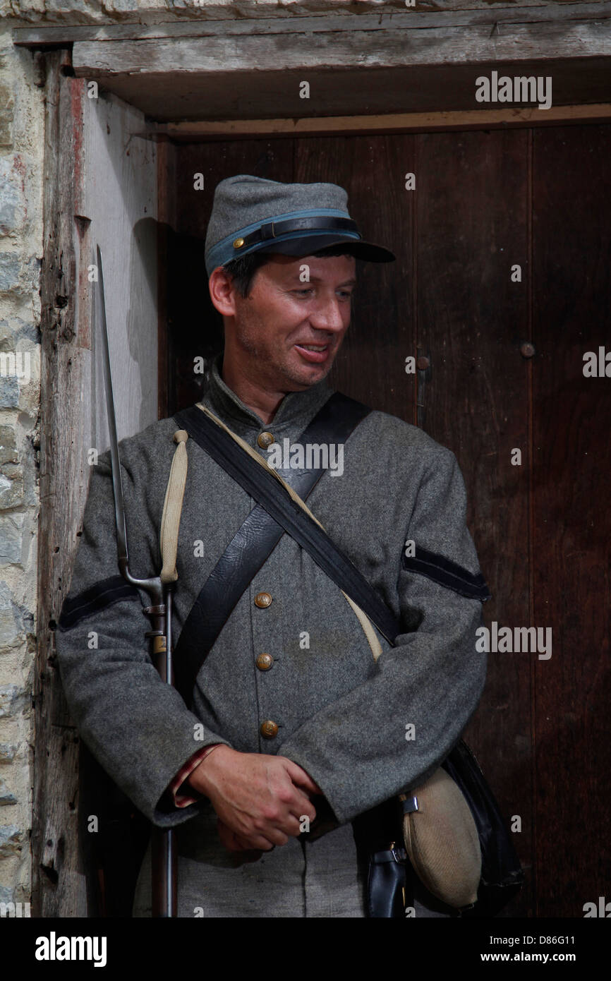 American civil war reenactor in uniform costume near old period ...