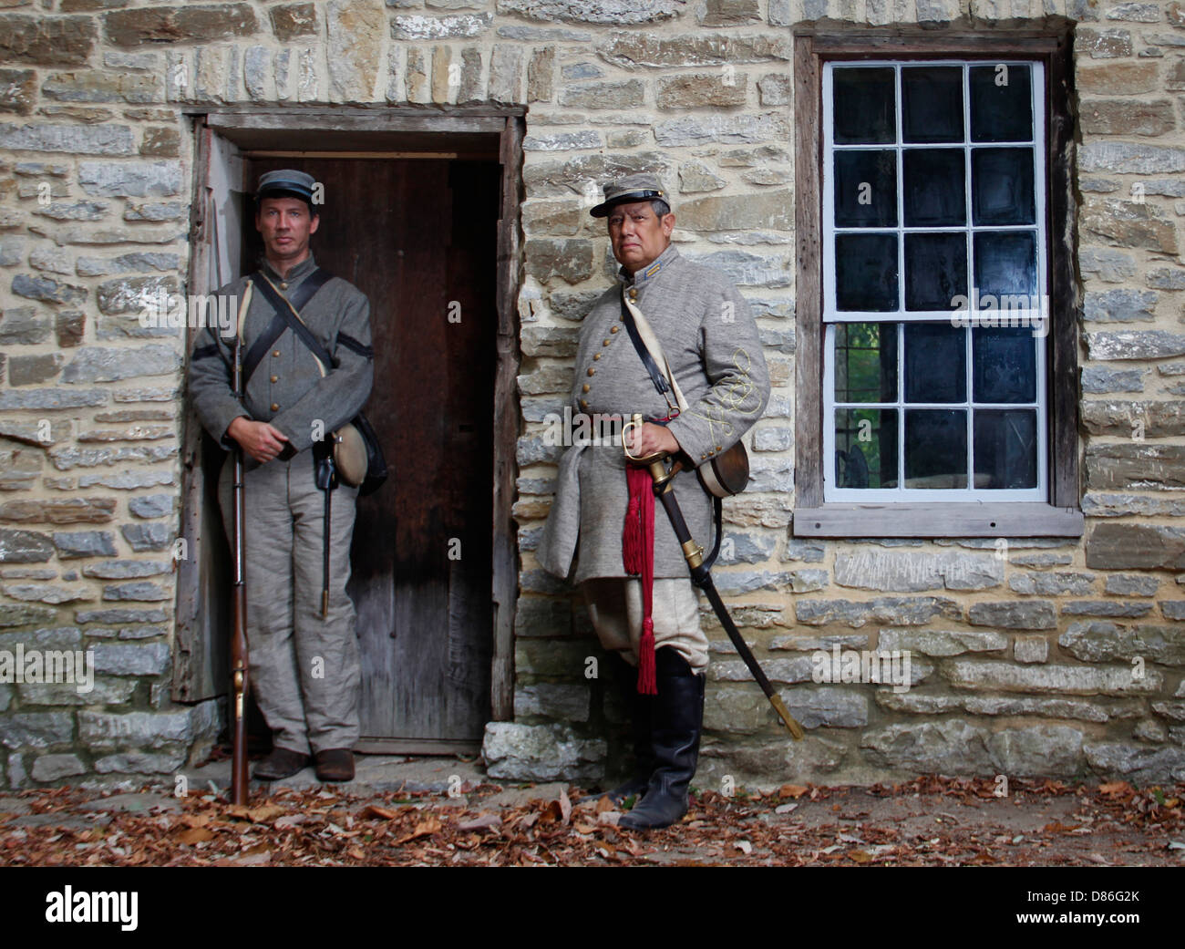 American civil war reenactor in uniform costume near old period ...