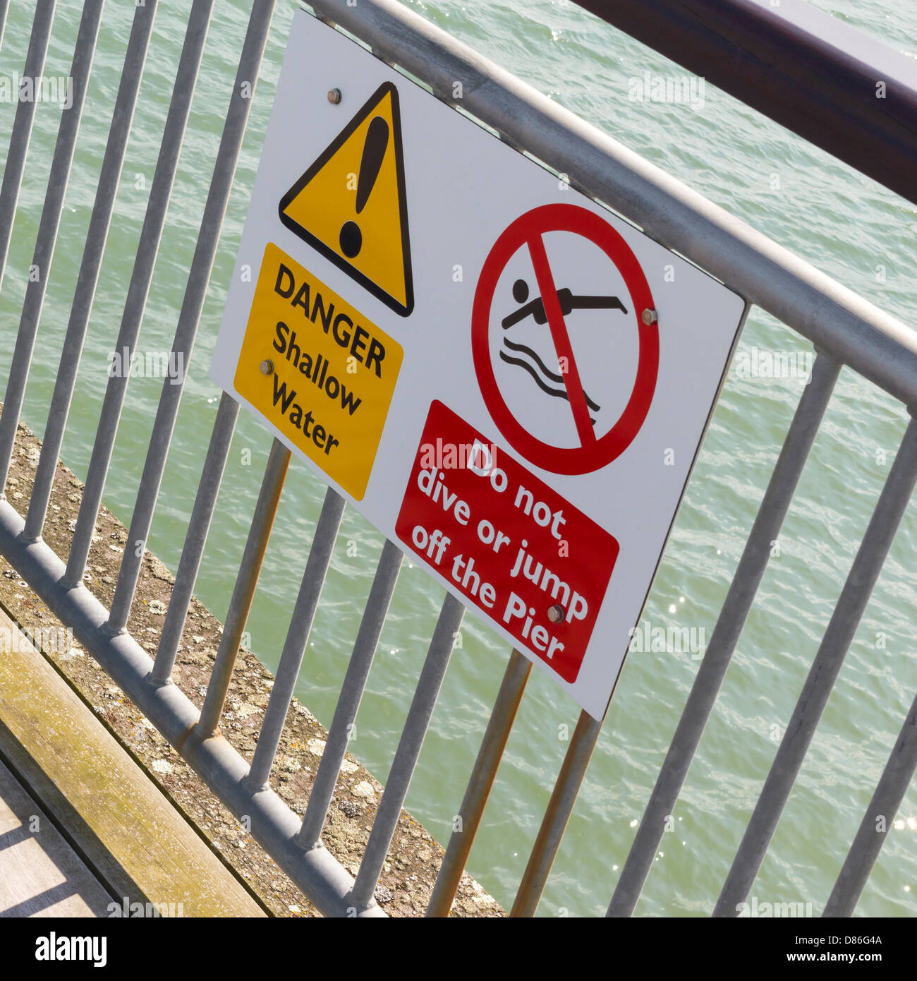 "Danger Shallow Water" and "Do not dive or jump off the Pier" warning ...
