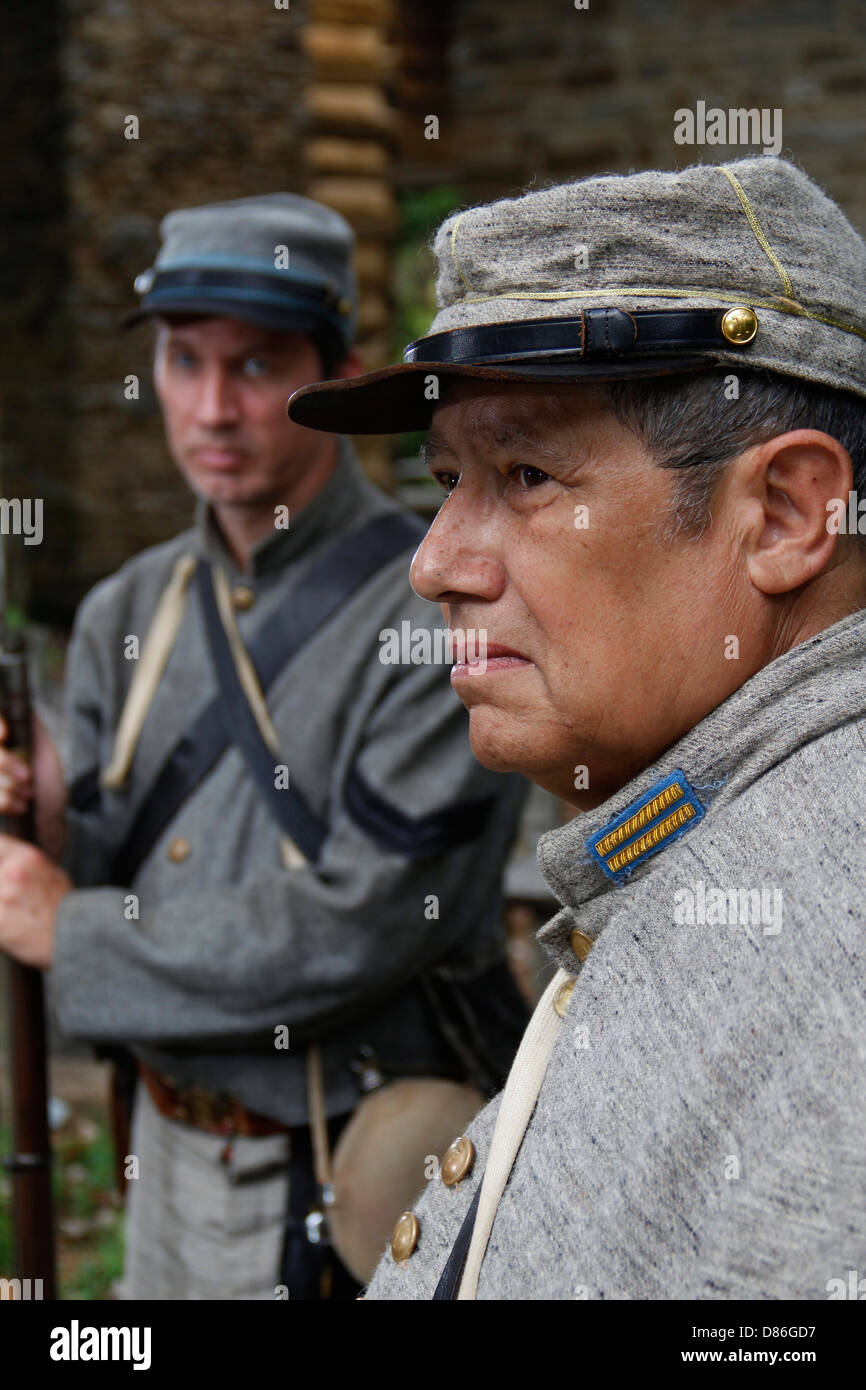 American civil war reenactor in uniform costume near old period ...