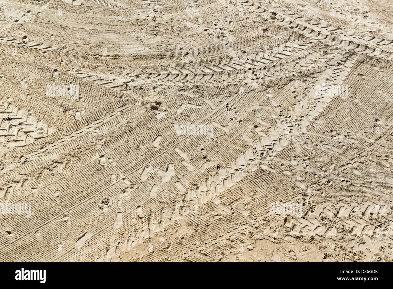 Tyre tracks and footprints on sand Stock Photo - Alamy