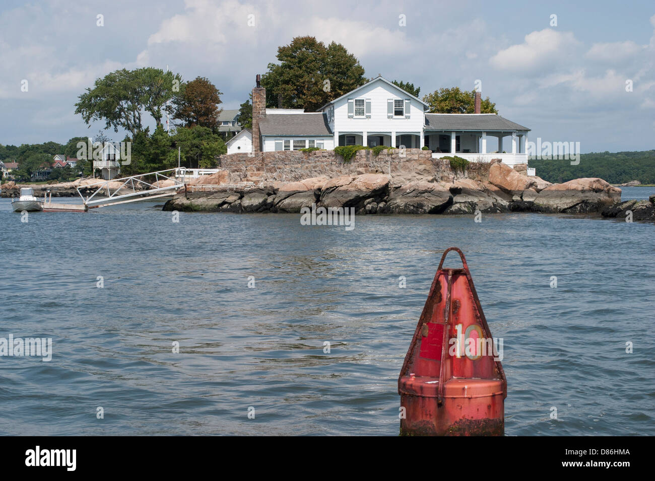 Homes are built close to the water on the rocky island shore in Long ...