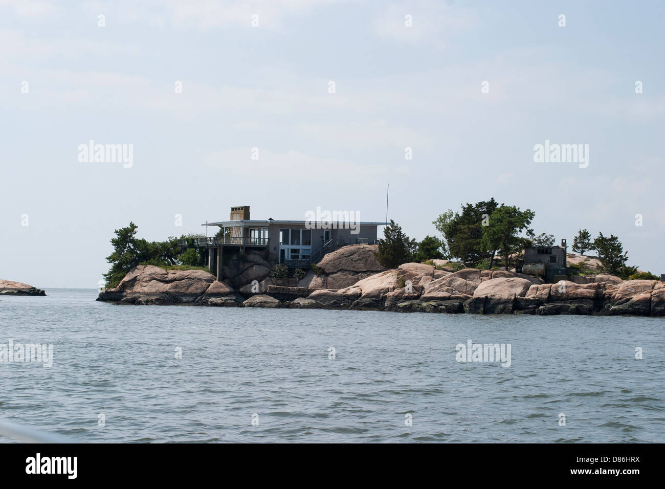 Homes are built close to the water on the rocky island shore in Long ...