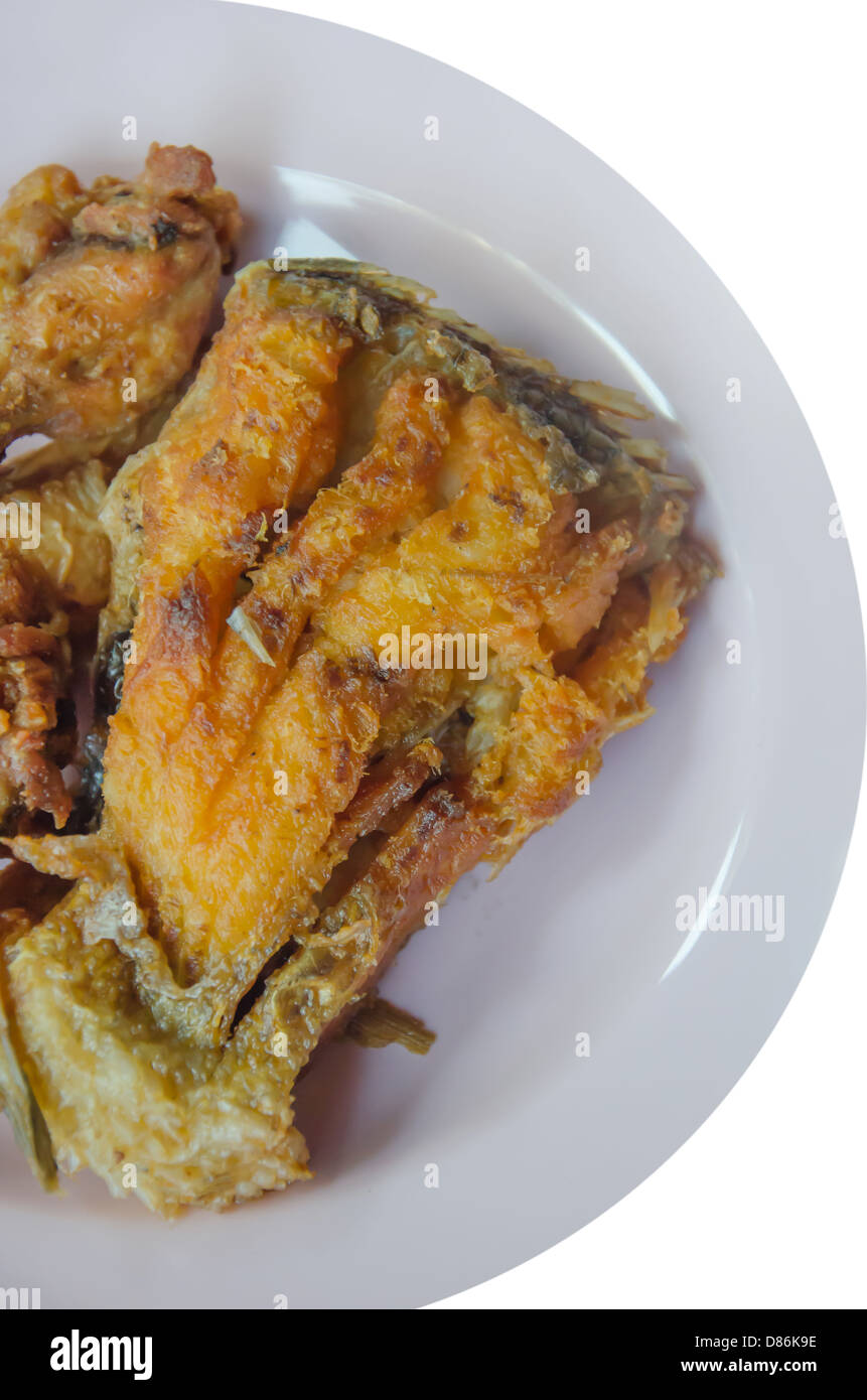 close up fried fish on dish over white background Stock Photo - Alamy