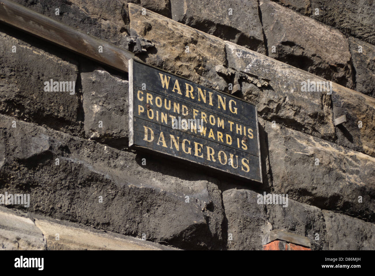 Aged Warning Sign. Ground from this point on is DANGEROUS Stock Photo ...