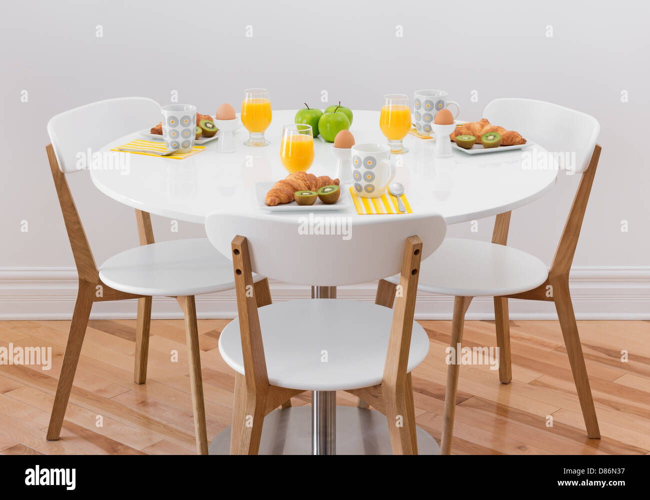 White round table with healthy breakfast for three Stock Photo - Alamy