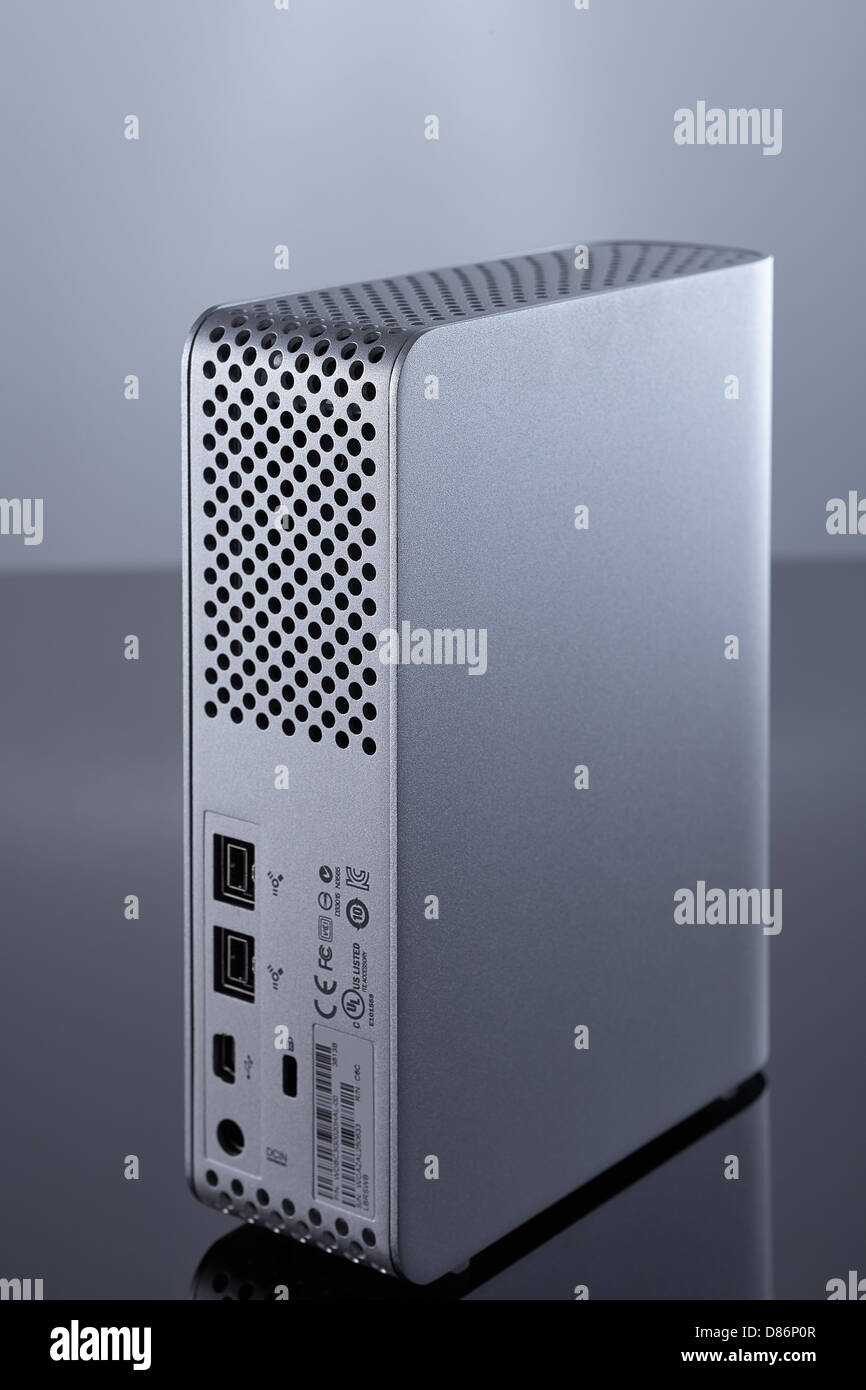 Back of a grey color external hard drive with grey background ...