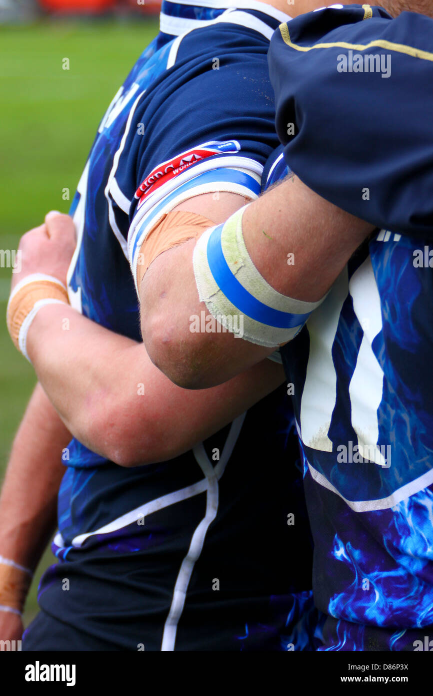 Rugby players in team huddle Stock Photo - Alamy