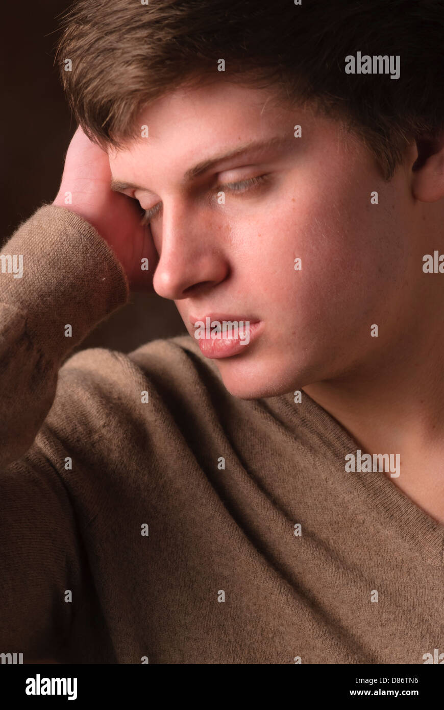 Teen male somewhat sad or depressed in a studio environment Stock Photo ...