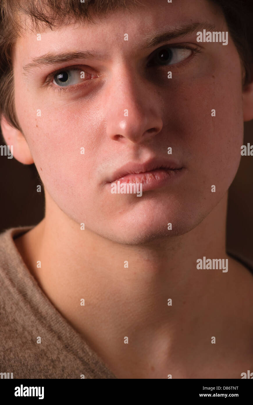 Troubled Teen waiting alone in studio shot Stock Photo - Alamy