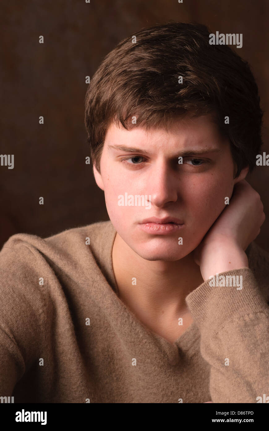 Troubled Teen waiting alone in studio shot Stock Photo - Alamy