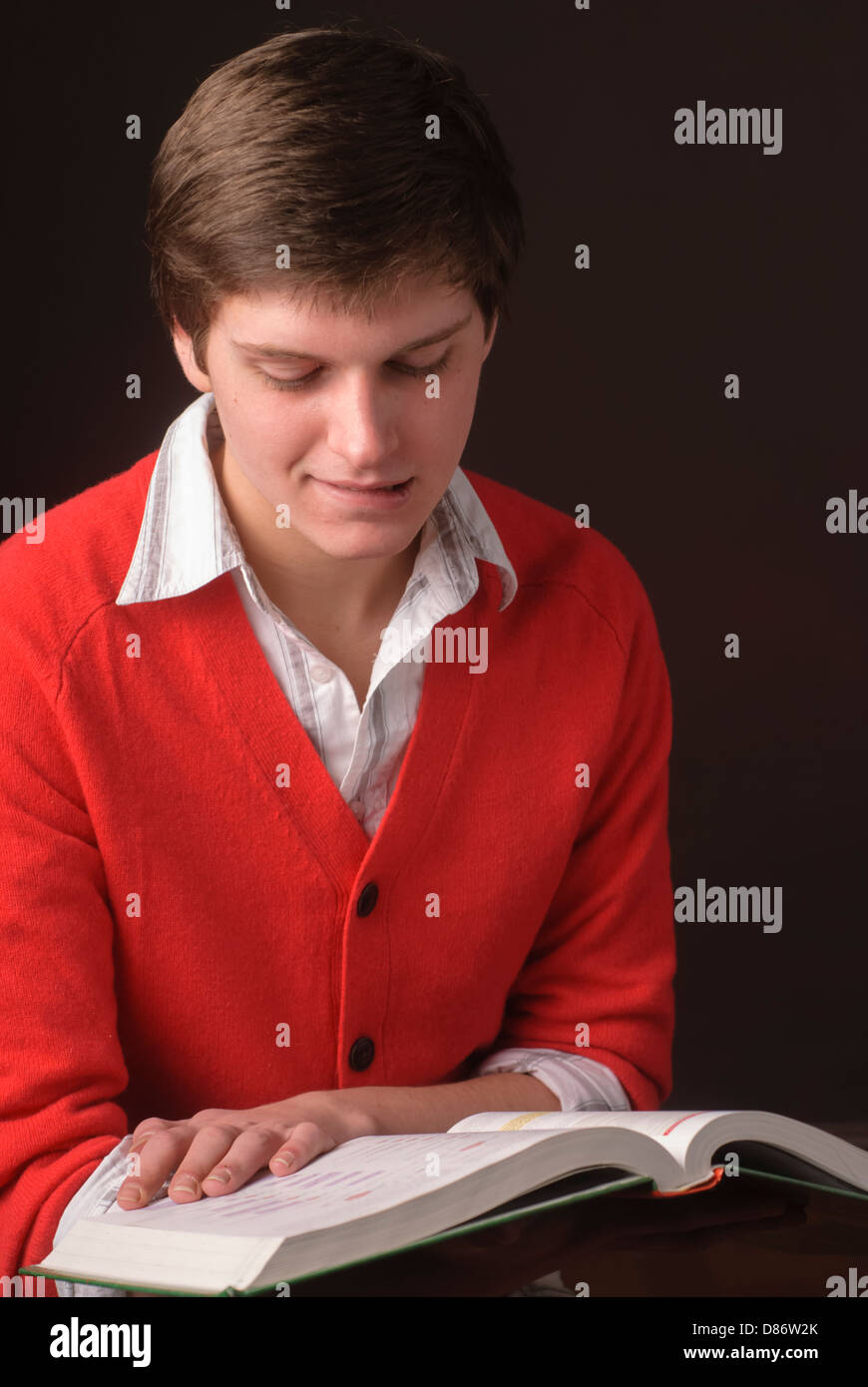 Student reading or studying a book Stock Photo - Alamy