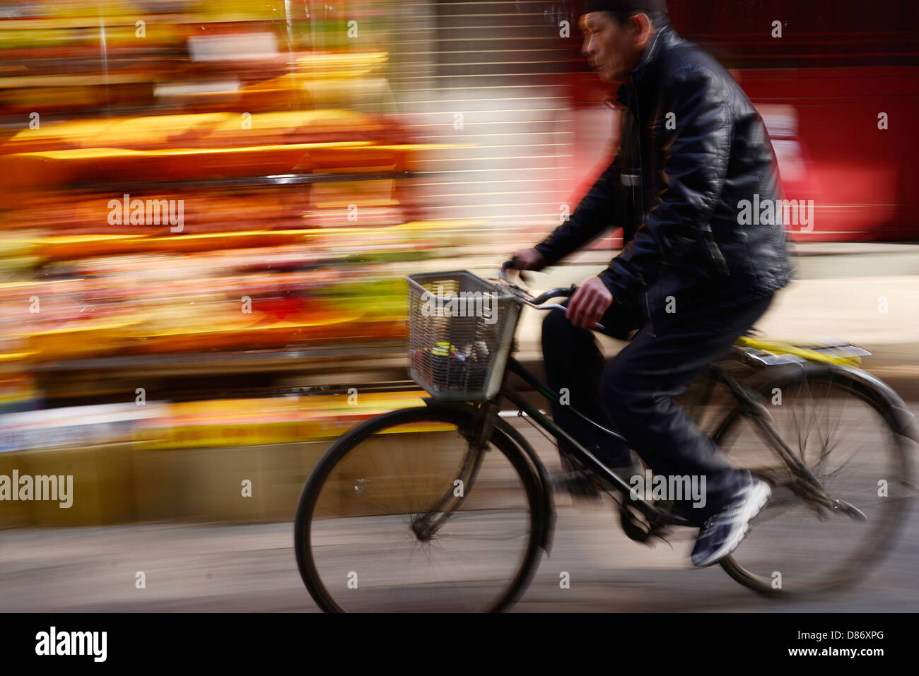 A Chinese man rushing on his cycle Stock Photo - Alamy