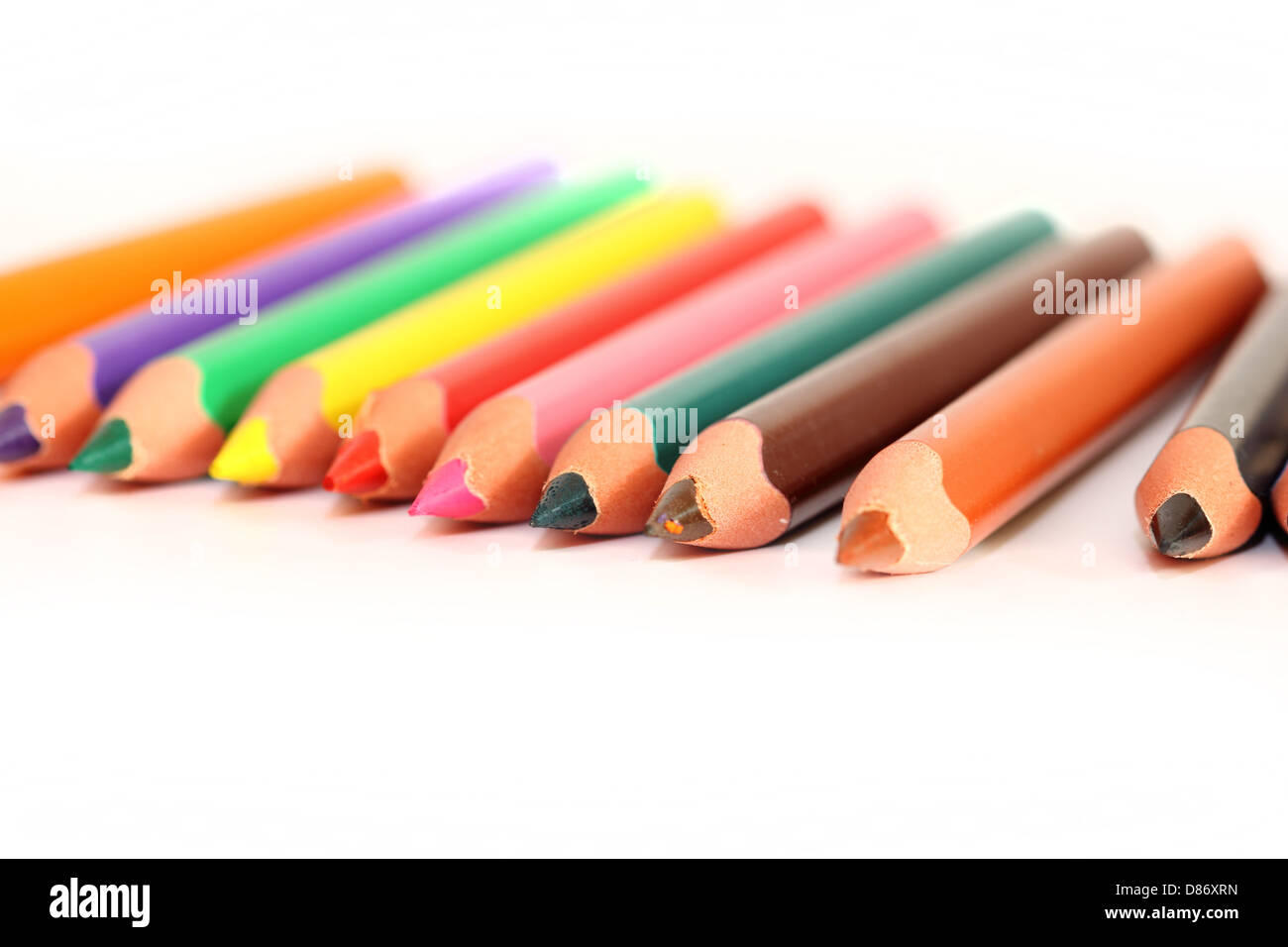 some bright colored pencils on white background Stock Photo - Alamy