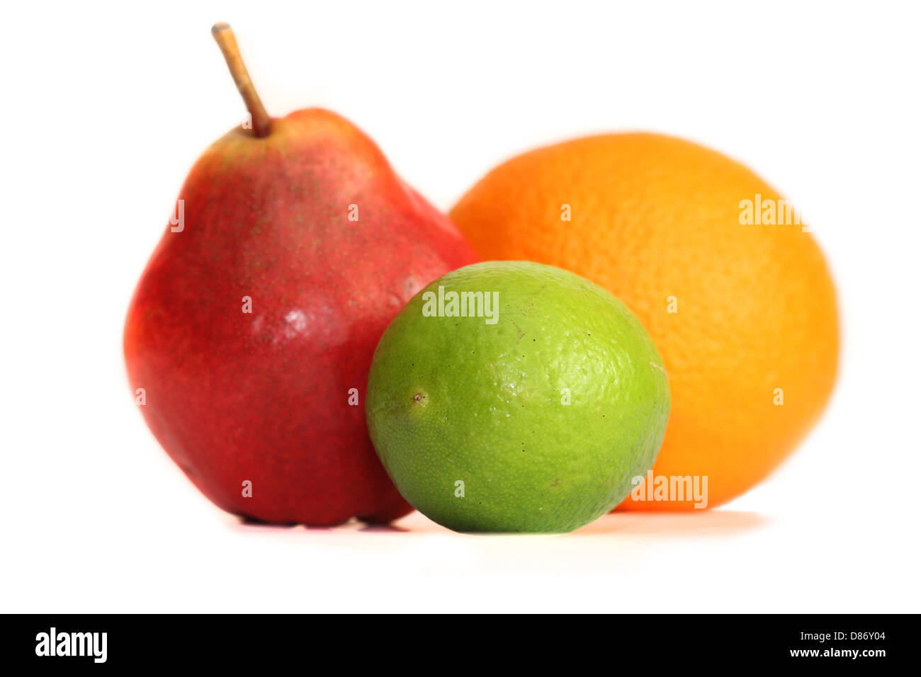 lime green, red ripe pear and orange Stock Photo - Alamy