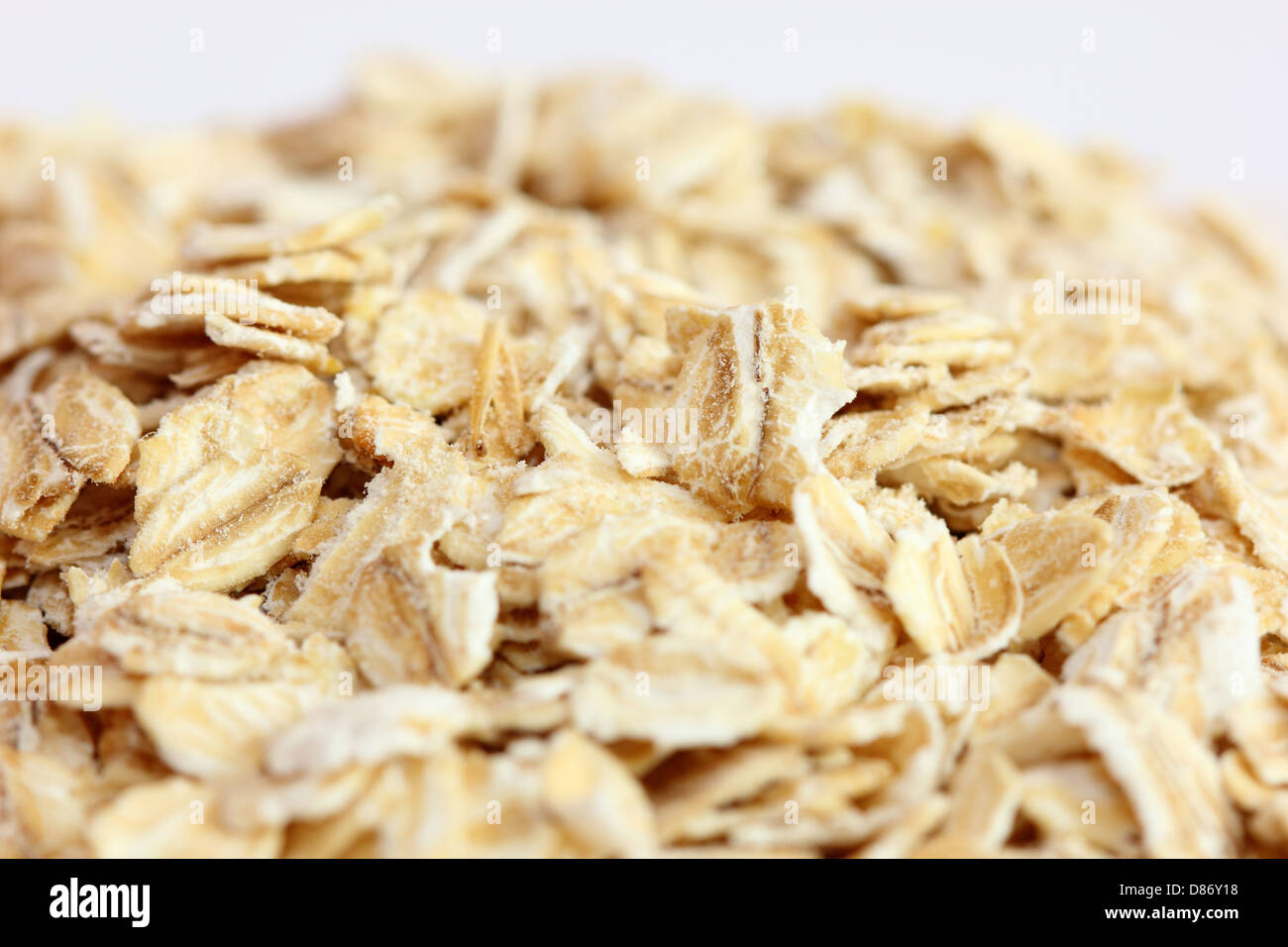 sprinkle oat flakes on a white background Stock Photo - Alamy