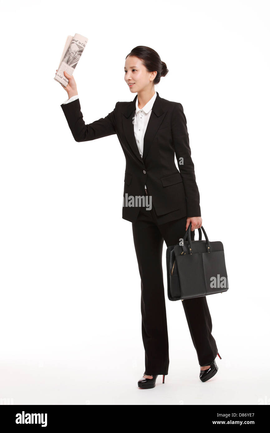young businesswoman posing in studio newspaper briefcase Stock Photo ...