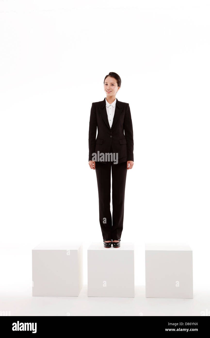 young businesswoman standing on box Stock Photo - Alamy