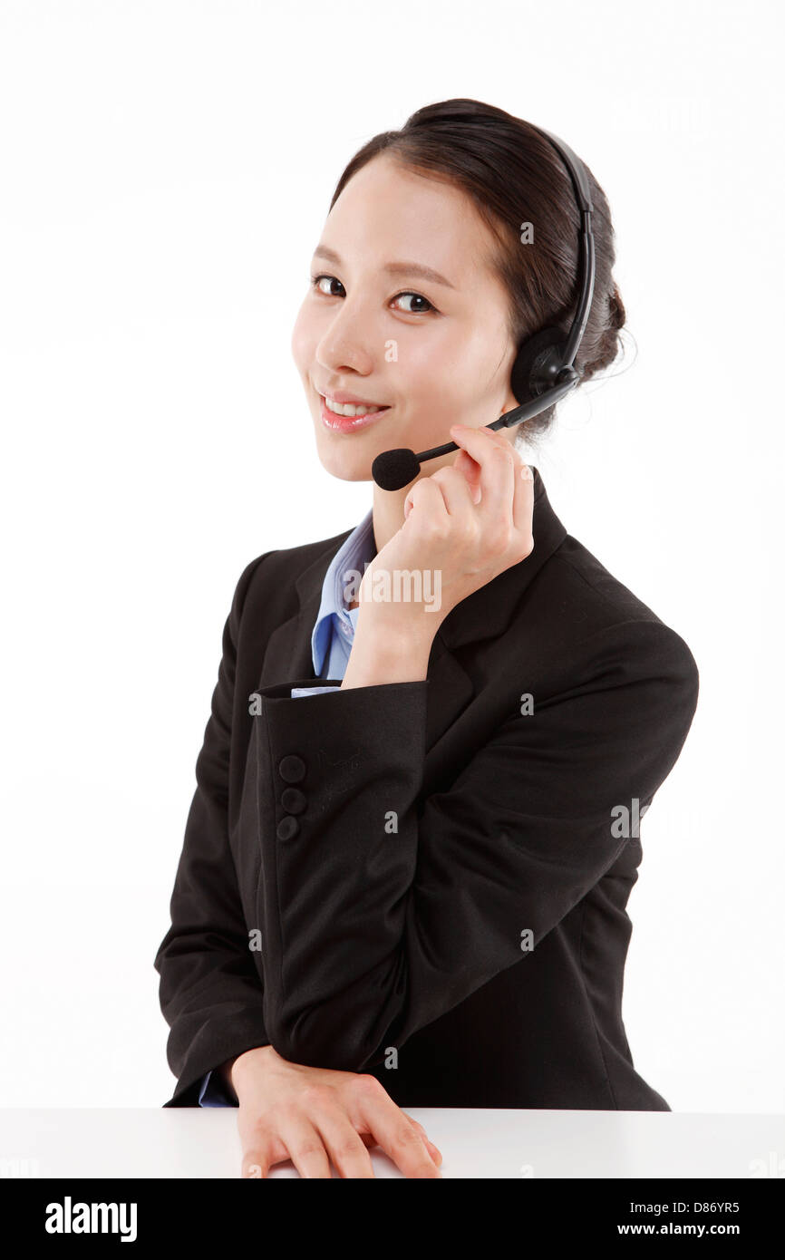 young woman sitting desk wearing headset Stock Photo - Alamy