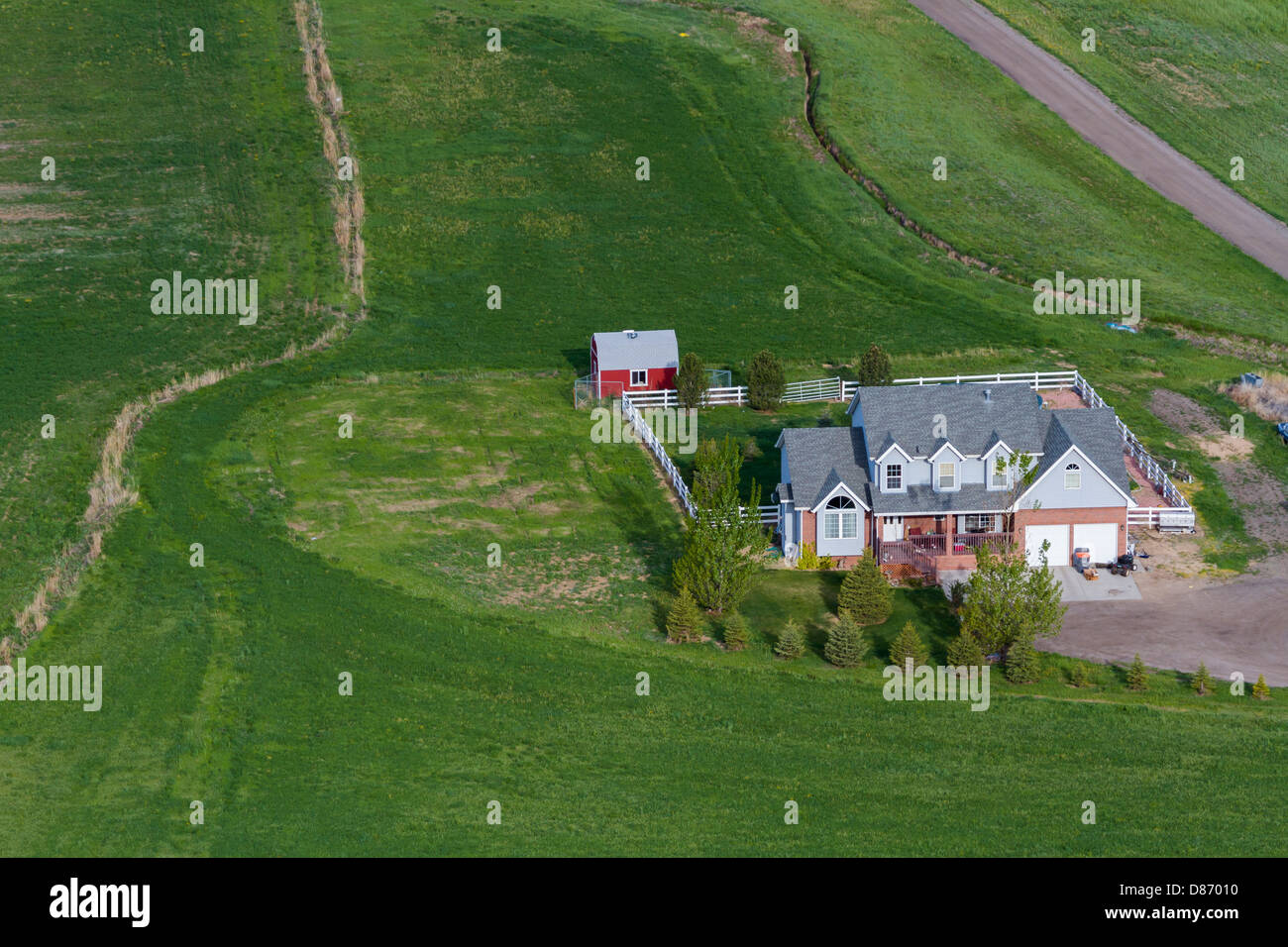 Large farm house on green field Stock Photo - Alamy