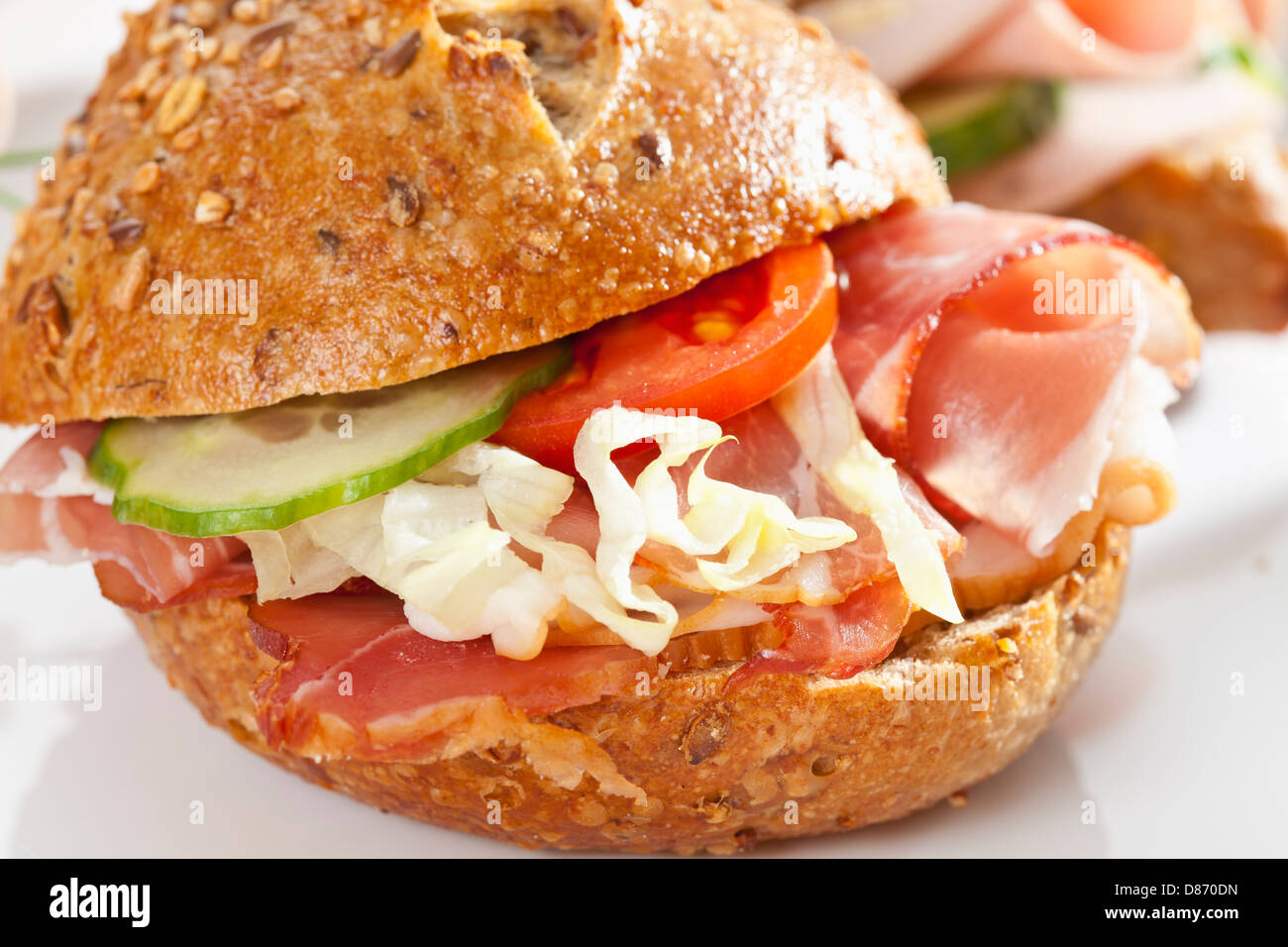 Variety of bread rolls sandwiches with mixed cold cuts on white ...