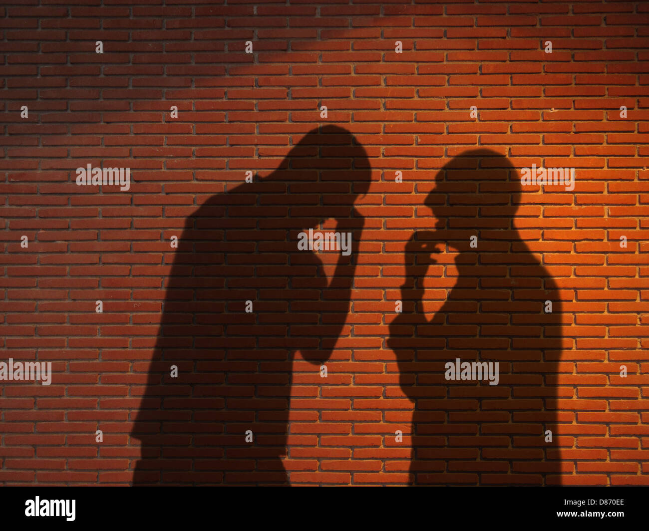 Shadow on a brick wall chatting Stock Photo - Alamy