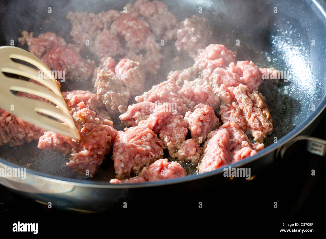 Roasting minced meat in frying pan, close up Stock Photo - Alamy
