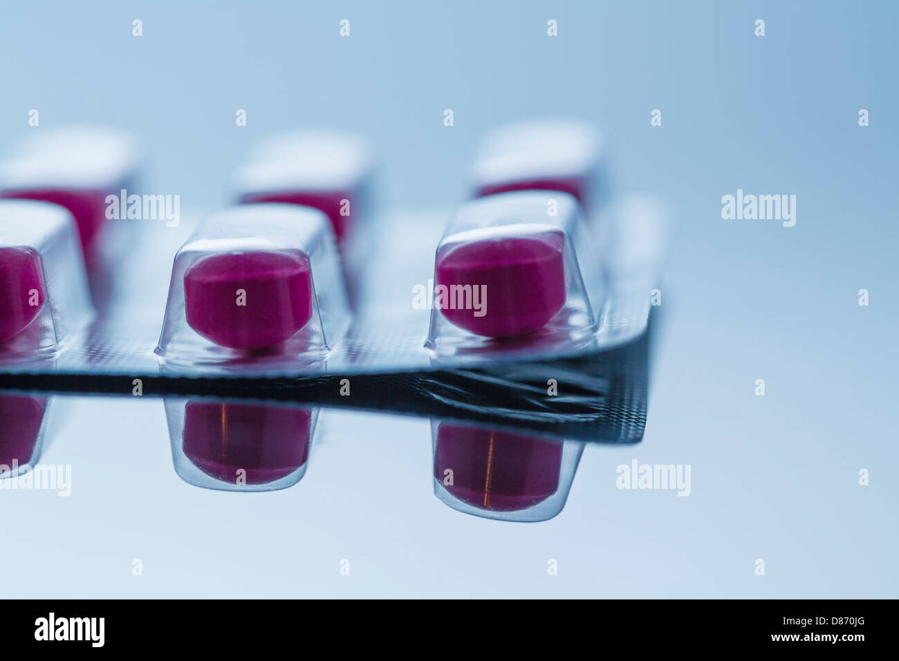 Blister pack of tablet on blue background, close up Stock Photo - Alamy